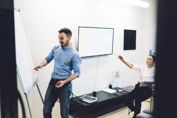 Male and female students in formal style clothes learning together on ...