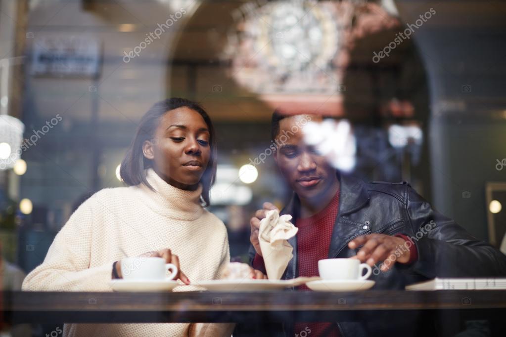 Two young friends talk and drink coffee in cafe, good friend enjoying ...