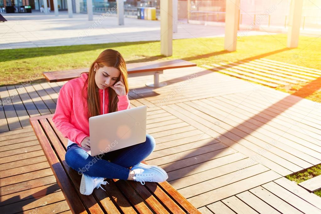 Female student focused using laptop — Stock Photo © GaudiLab #69204887