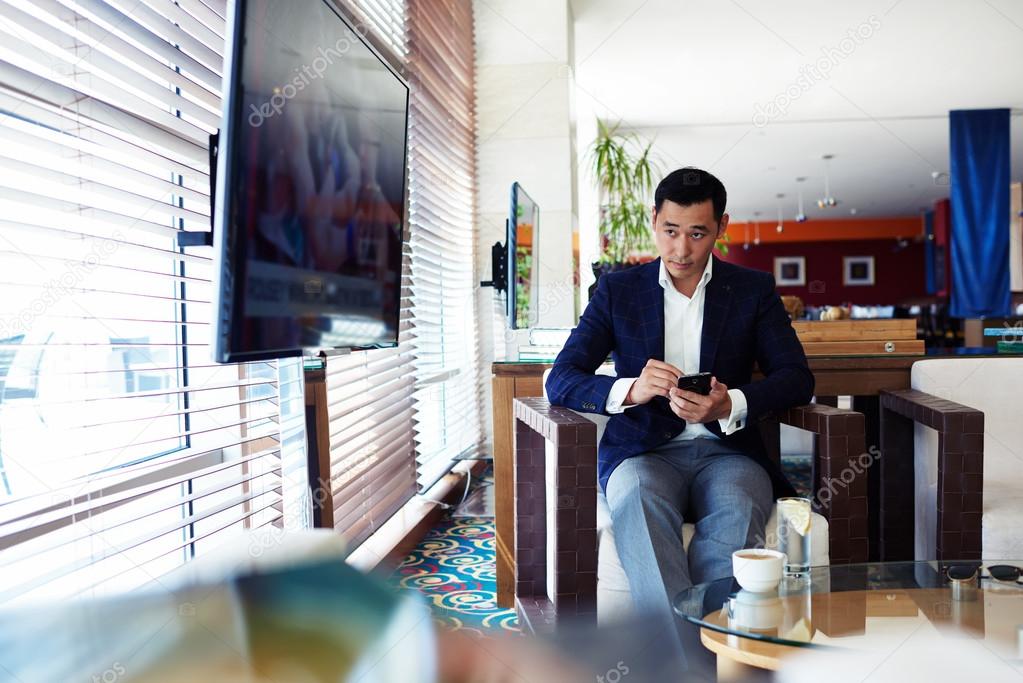 Asian businessman using mobile phone — Stock Photo © GaudiLab #88865862