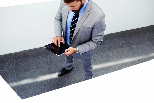 Businessman working on touch pad in office - Stock Image - Everypixel