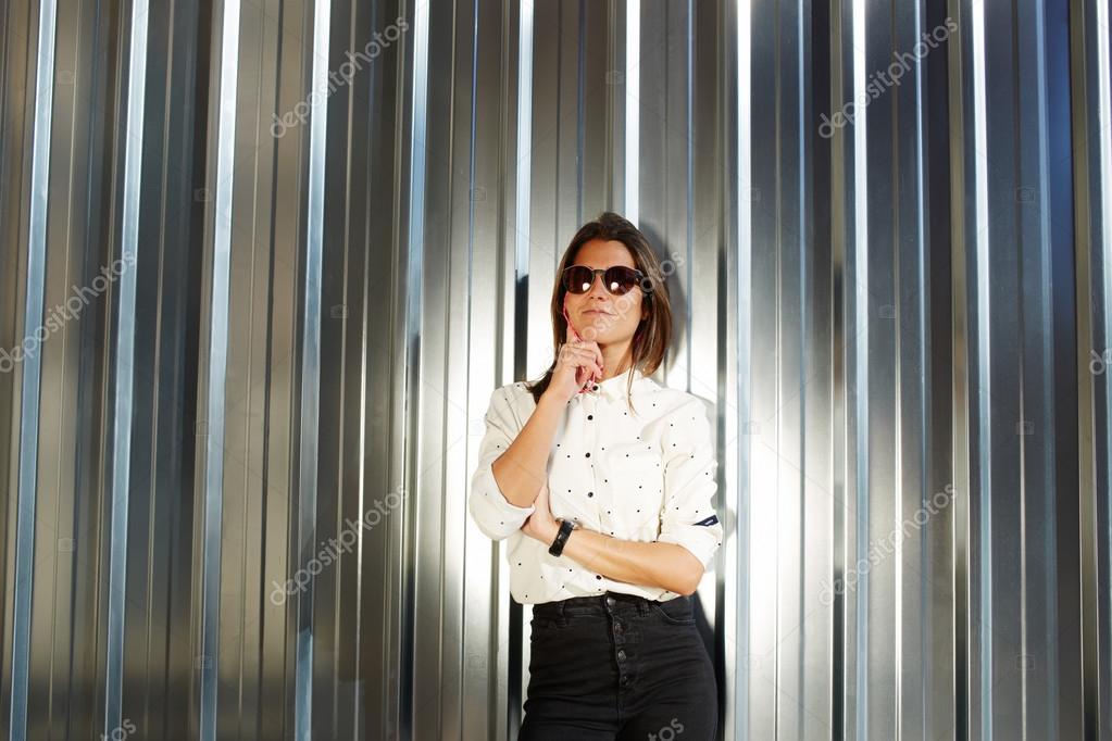 Model in black sunglasses posing outdoors Stock Photo by ©GaudiLab 92565192