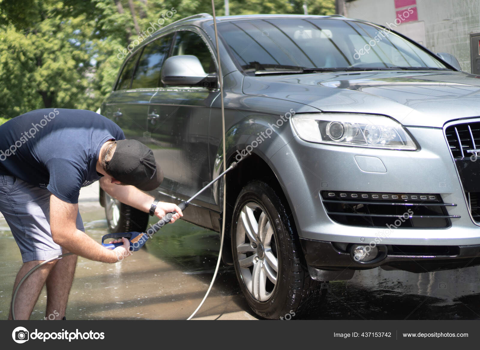 Washing car tires. Car wash with high pressure washer. Water jet during ...
