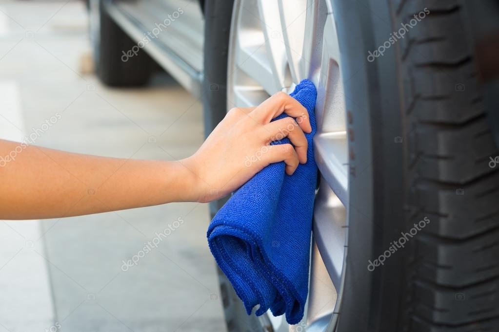 Wiping alloy wheels Stock Photo by ©roncivil 90454116