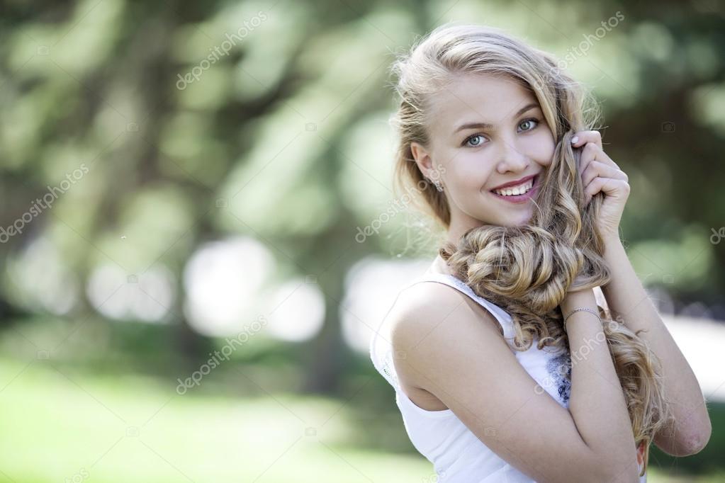 Girl with beautiful smile and long hair in the street Stock Photo by ...