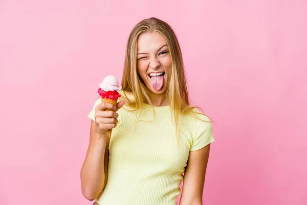 Young russian woman eating an ice cream isolated funny and friendly ...