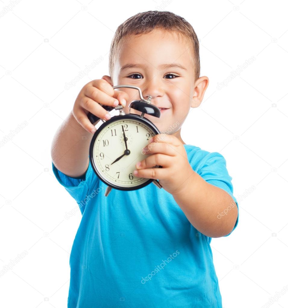 Cheerful child holding clock Stock Photo by ©AsierRomeroCarballo 67011679