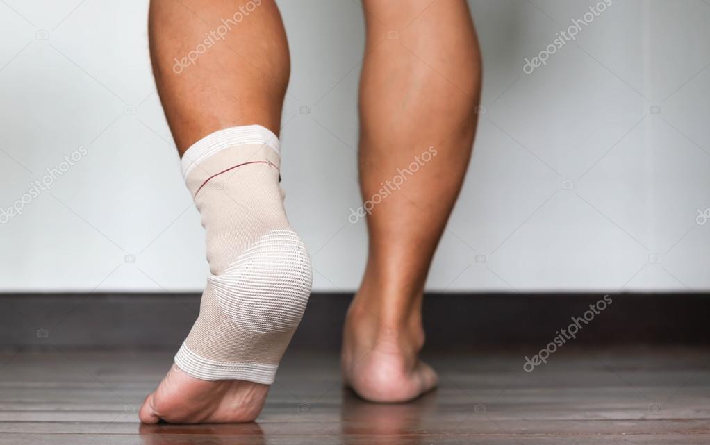 Injured ankle and foot wrapped in bandage Stock Photo by ©Bignai 84250688