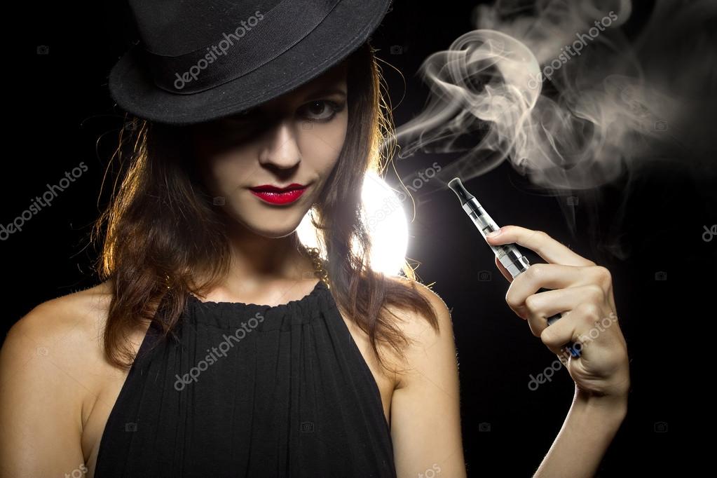 Woman vaping an electronic cigarette Stock Photo by ©innovatedcaptures ...