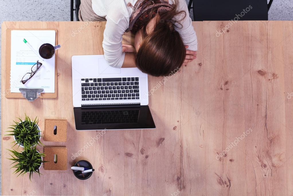 Young woman sleeping on laptop in the workplace Stock Photo by ...