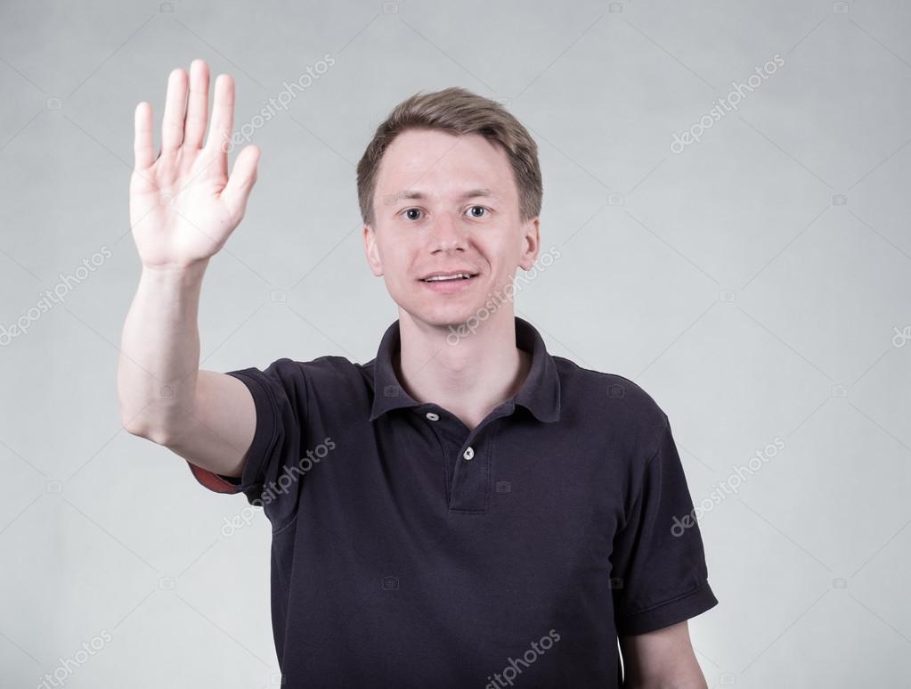 Young guy say hello Stock Photo by ©filistimlyanin 111545392