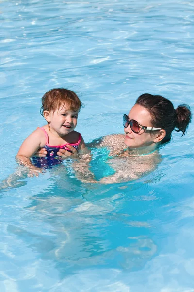 Family in swimming pool playing - Stock Image - Everypixel