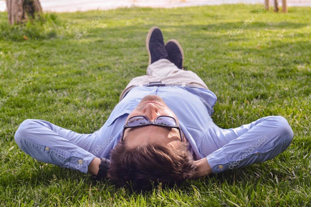 Businessman lie down on the grass ground Stock Photo by ©patlakpiksels ...