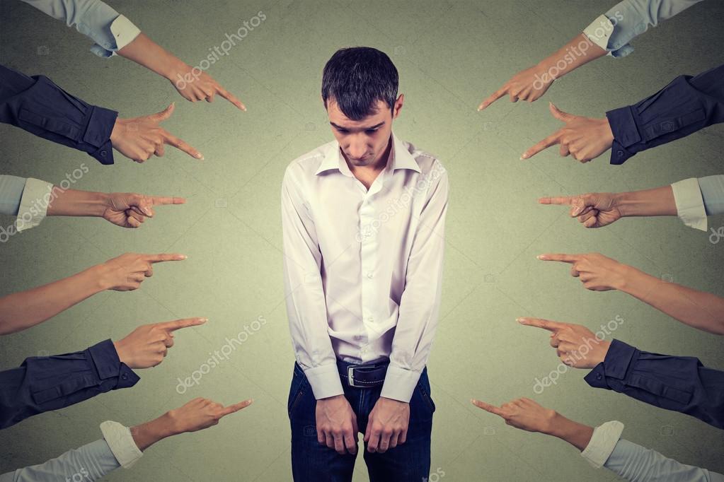 Accusation of guilty guy. Sad upset man looking down many fingers ...