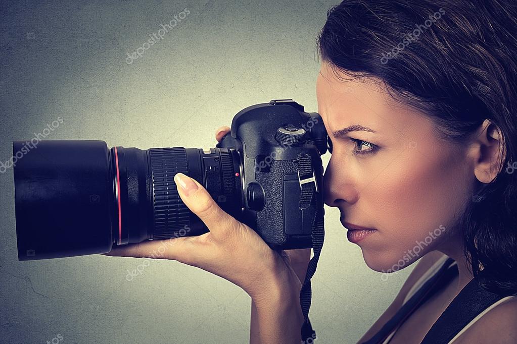 Side profile young woman taking pictures with professional camera ...