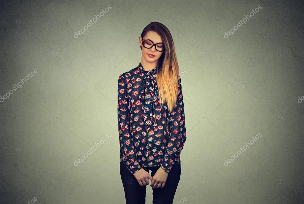 Sad shy insecure young woman in glasses looking down avoiding eye ...