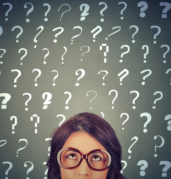 Portrait young woman with many question marks above her head - Stock ...