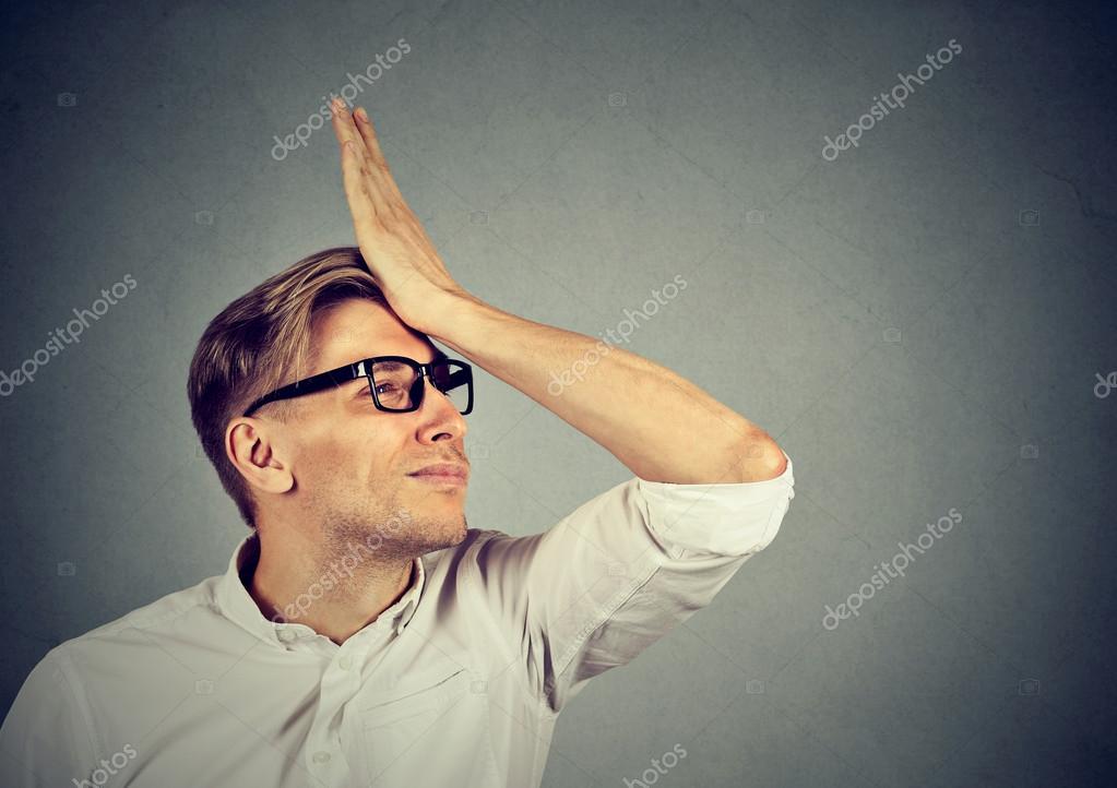 Silly man slapping hand on head having duh moment Stock Photo by ...