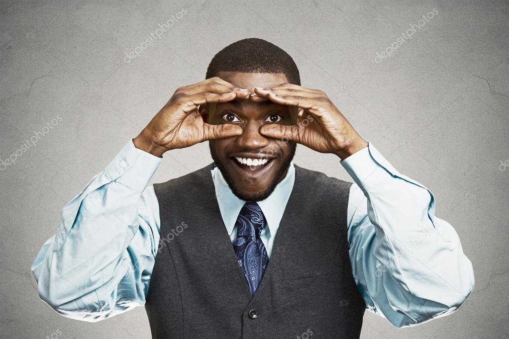 Man, looking curious, surprised, shocked through fingers like bi Stock ...