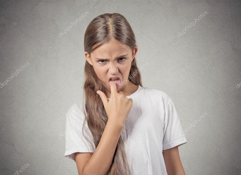 Disgusted, annoyed pissed off teenager girl with finger in mouth ...