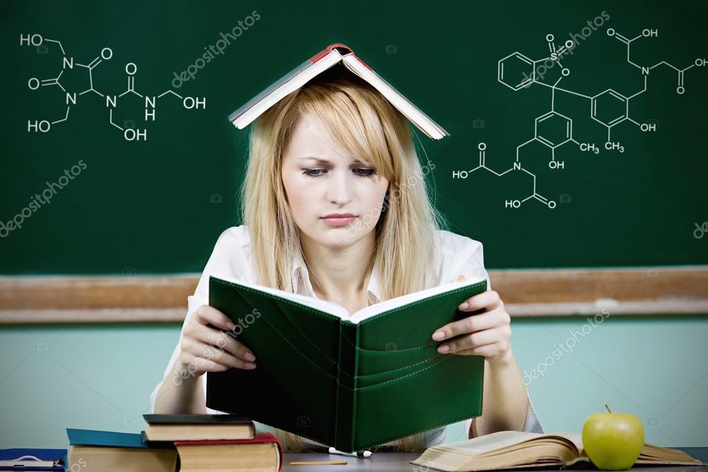 Overwhelmed student reading book studying preparing finals — Stock ...