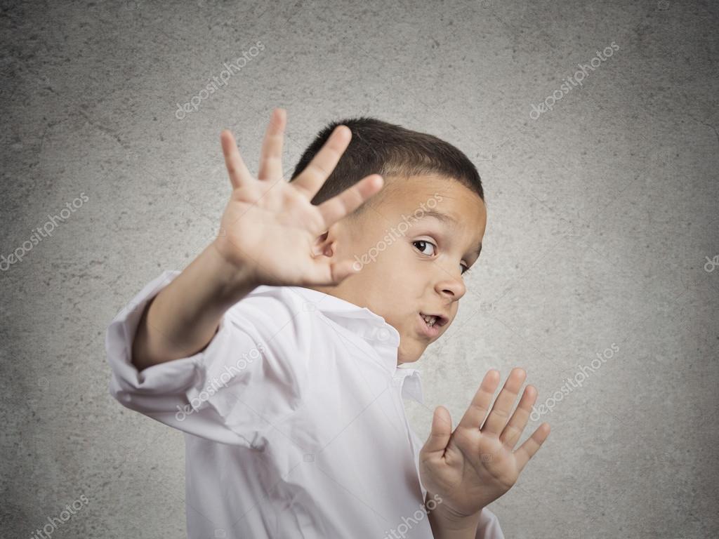 Child boy looking scared trying to protect himself Stock Photo by ...