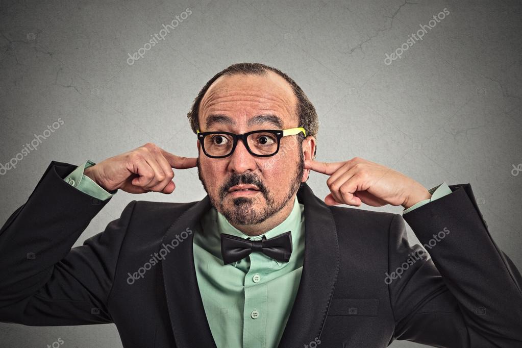 Annoyed mature man with glasses plugging ears with fingers — Stock ...