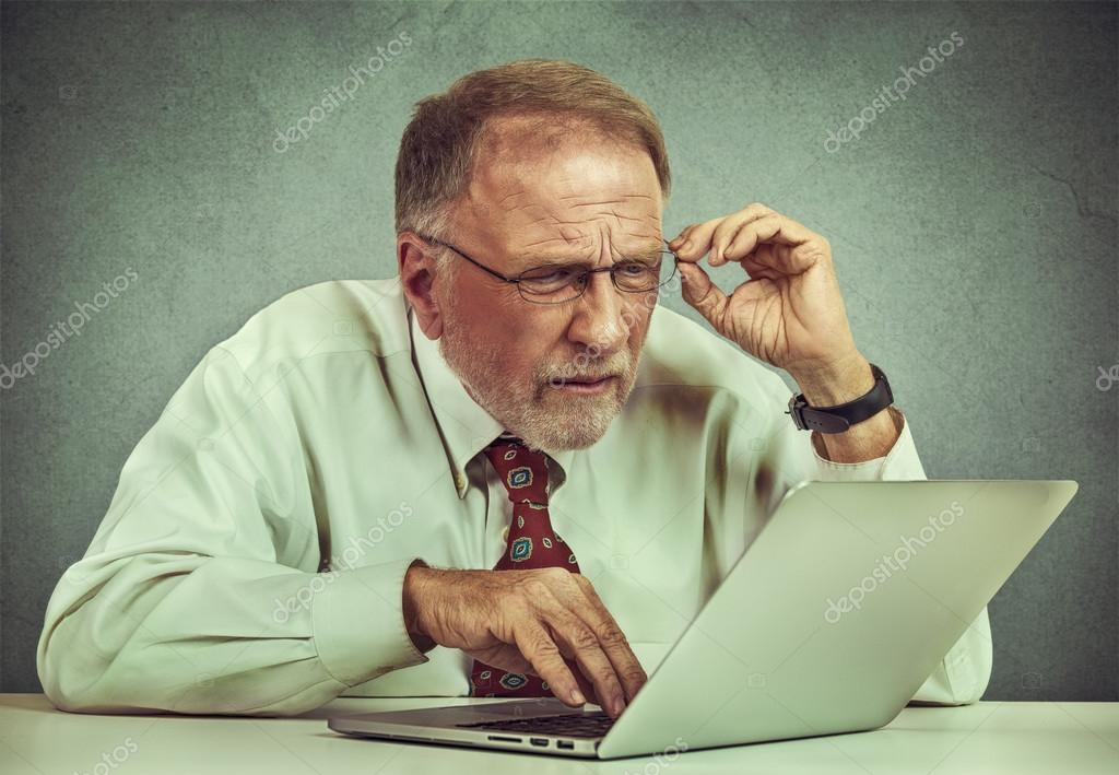 Elderly man with glasses confused with laptop software Stock Photo by ... Elderly man with glasses confused with laptop software Stock Photo by ...