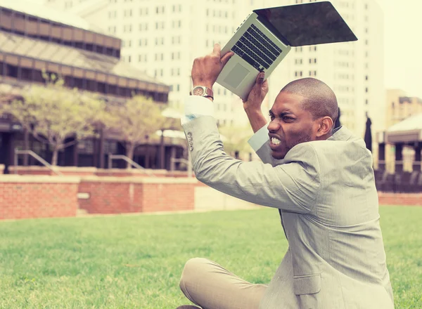 Angry business man throwing his tablet computer, laptop - Stock Image ...