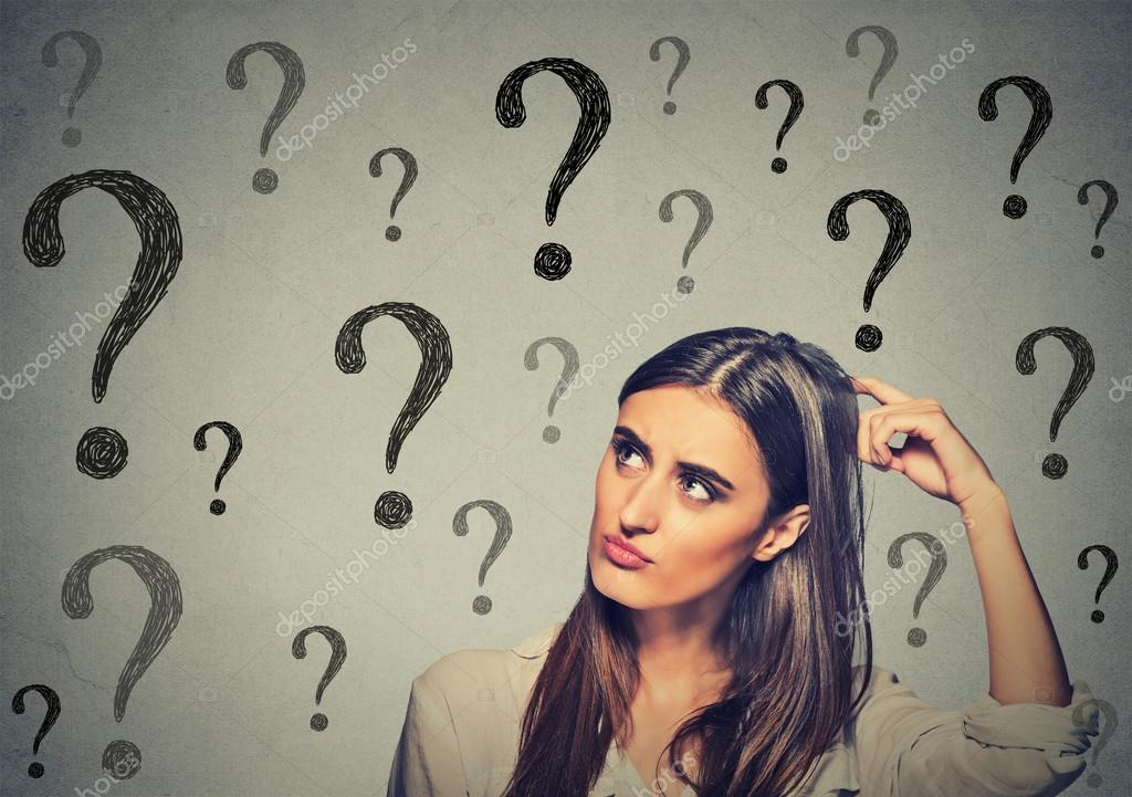 Confused thinking woman scratching her head looking up at many question ...