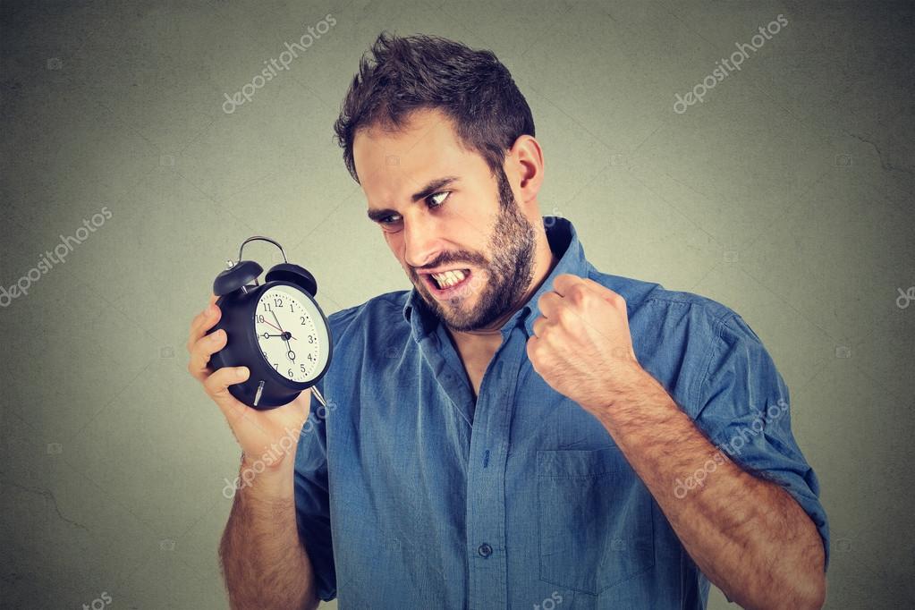 Angry young man screaming at alarm clock, running late — Stock Photo ...