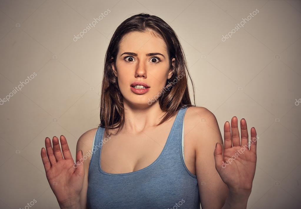 Concerned scared woman dodging something arms raised — Stock Photo ...