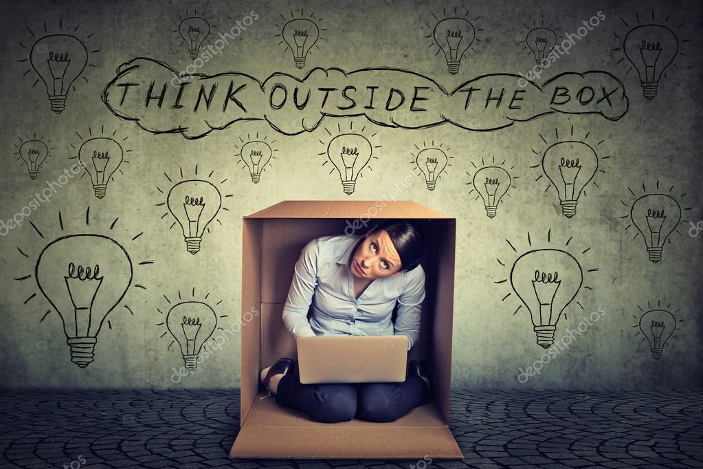 Think outside the box concept. Woman sitting inside box using working ...