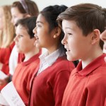 Group Of School Children Singing In Choir Together Stock Photo by ...