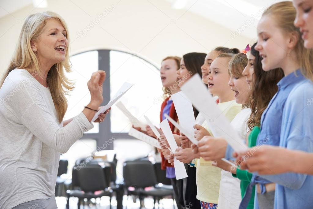 Children In Singing Group Being Encouraged By Teacher — Stock Photo ...