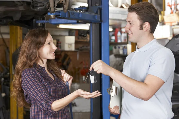 Satisfied Customer Collecting Car From Garage Mechanic - Stock Image ...