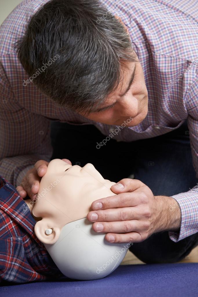 Man In First Aid Class Checking Airway On CPR Dummy — Stock Photo ...