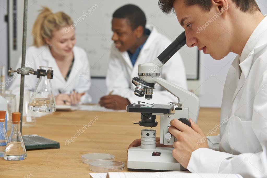 Teenage Students In Science Class Using Microscope Stock Photo by ...