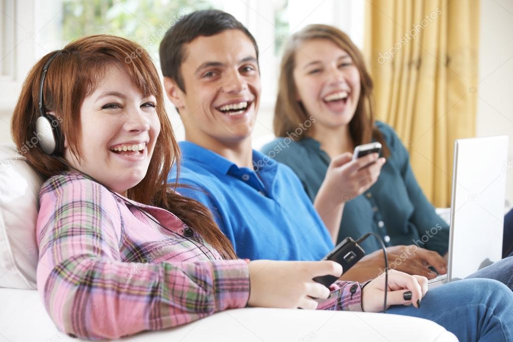 Group Of Friends Using Digital Technology At Home — Stock Photo ...