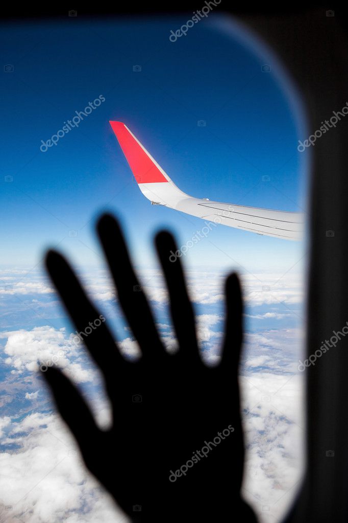 Woman hand on a aeroplane window Stock Photo by ©erstudio 89771886