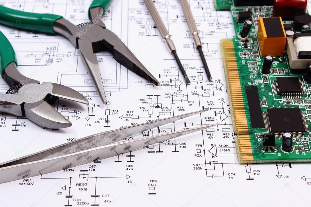 Printed circuit board and precision tools on diagram of electronics ...