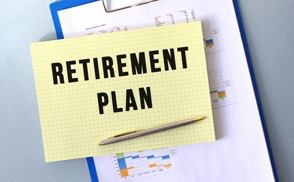 RETIREMENT PLAN text written on notepad with pencil. Notepad on a ...