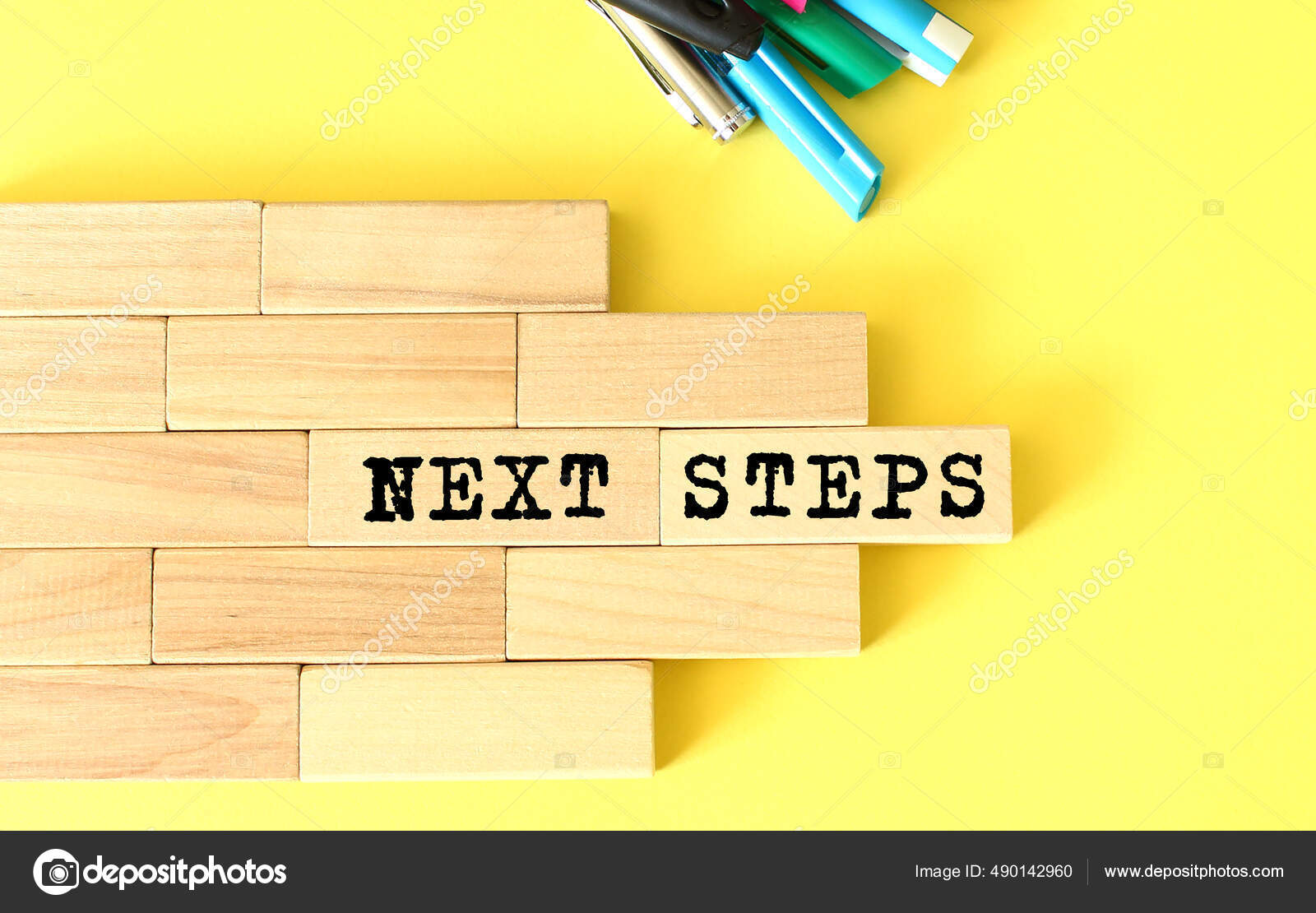 Wooden Blocks Stacked Next Pens Pencils Yellow Background Next Steps ...