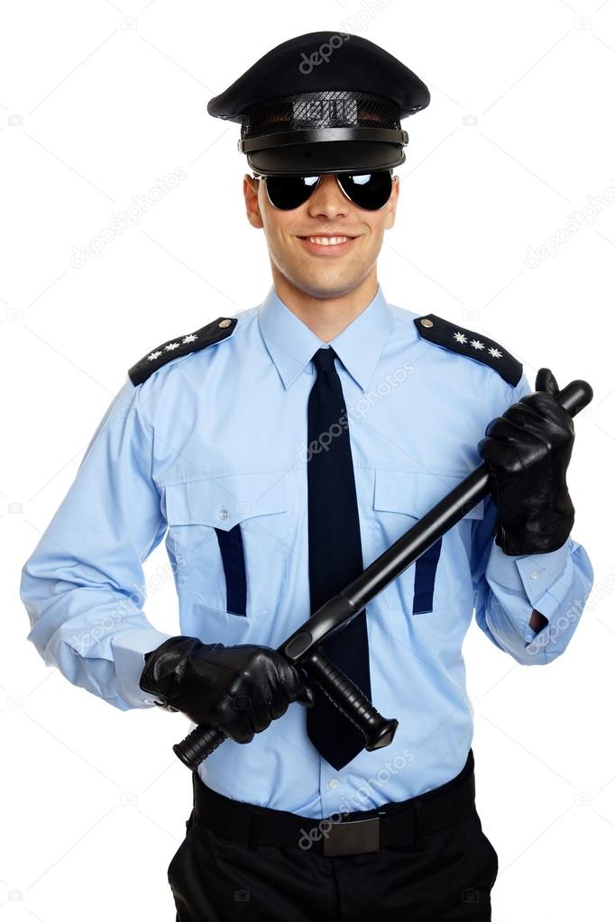 Policeman holds nightstick in hands — Stock Photo © petrdlouhy #64472105
