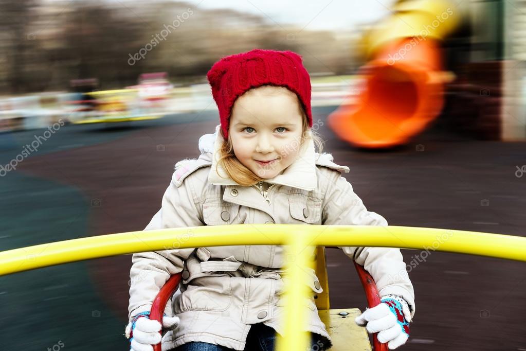 Cute little girl rounding on merry-go-round Stock Photo by ©sorokopud ...