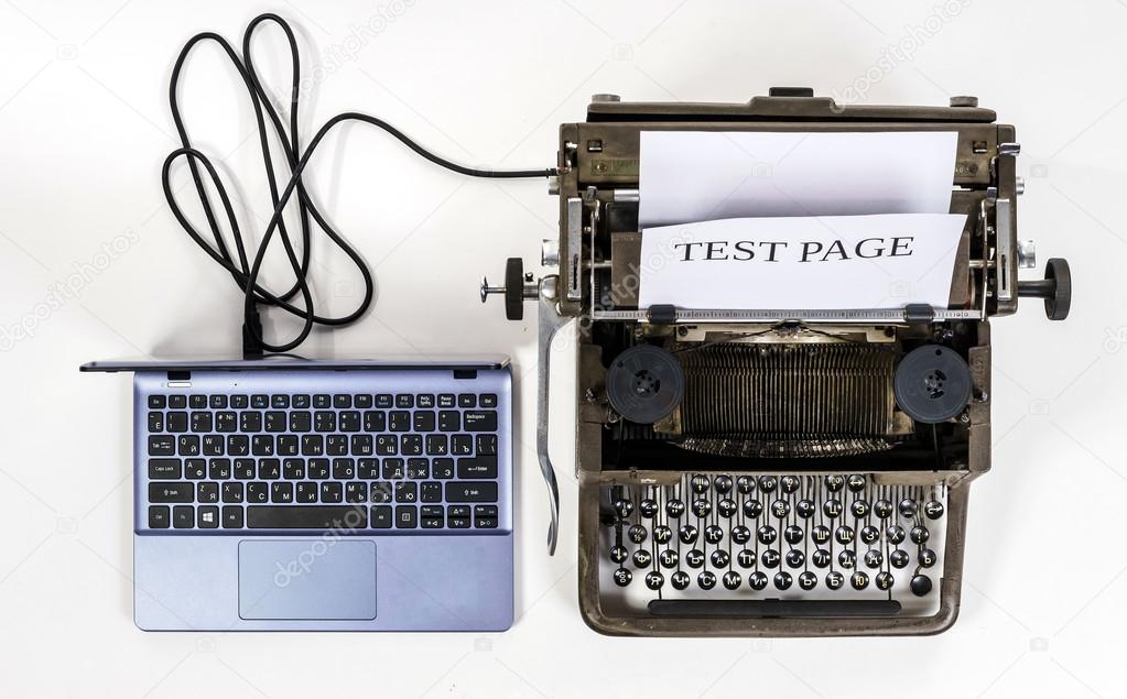 New laptop computer printing page to old vintage typewriter Stock Photo ...