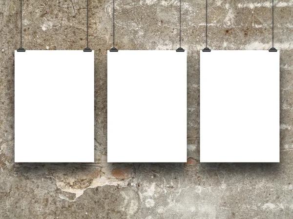 Three vertical paper sheets on brown wall - Stock Image - Everypixel