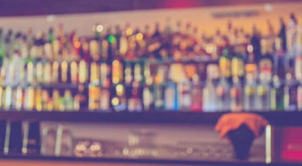 vintage tone blur image of blur wood table in dark bar interior for ...