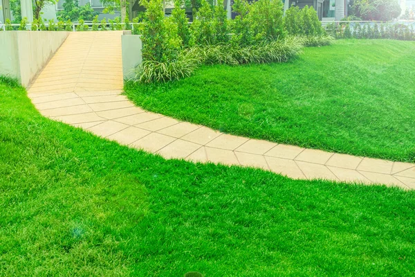 Wheelchair access ramp was built in a park with a bright green lawn ...