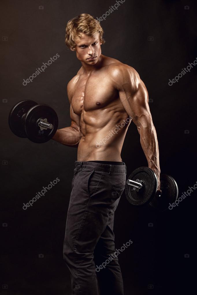 Muscular bodybuilder guy doing exercises with dumbbells Stock Photo by ...